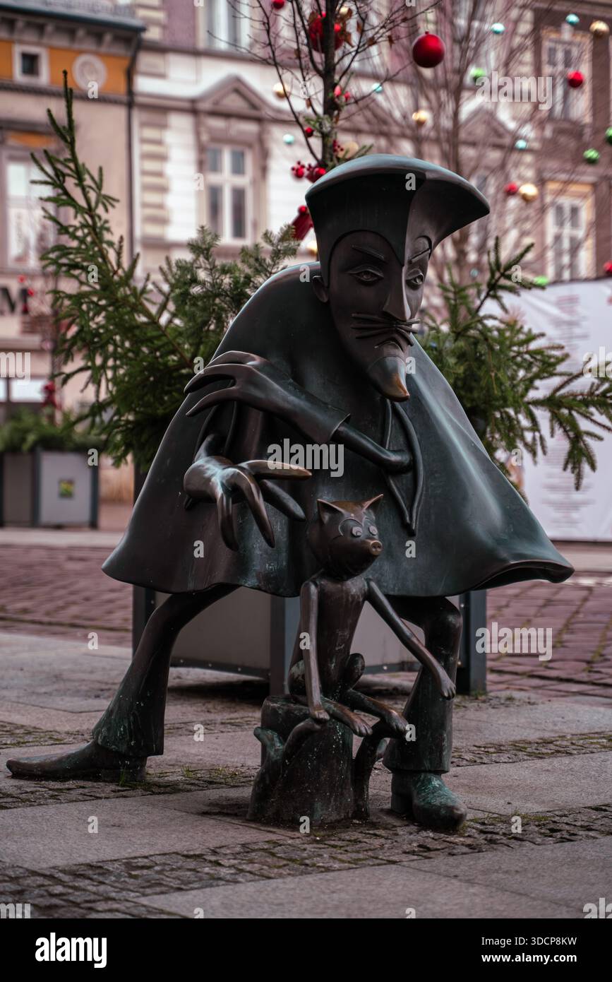 Statue of Don Pedro the spy with a cat in Bielsko-Biala. The man wears ...
