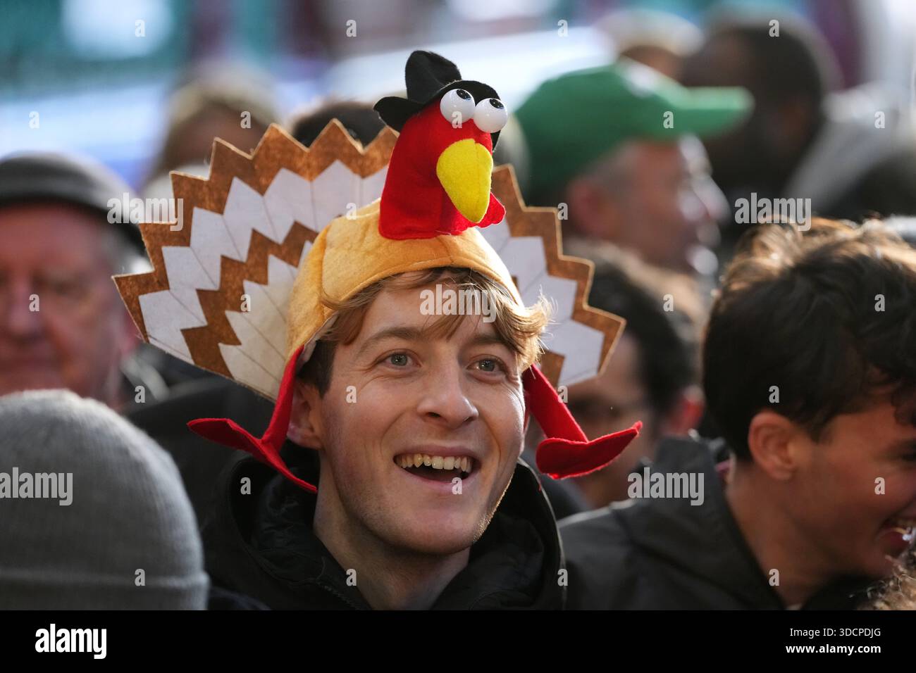 A man wears a festive hat during the annual Christmas Eve meat auction ...