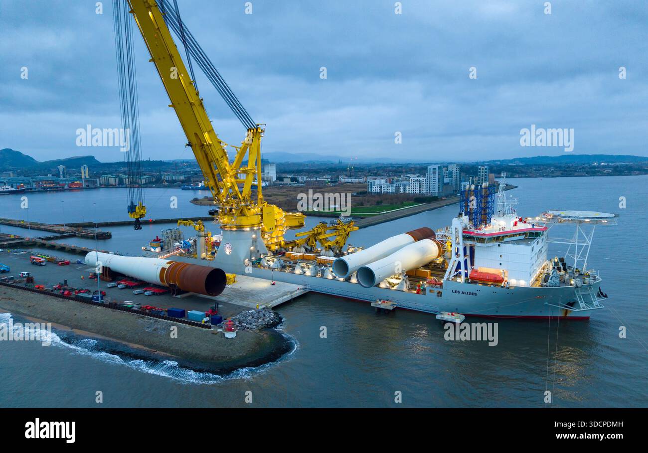 MV Les Alizes, loads wind turbine monopiles at Leith Port. The piles ...