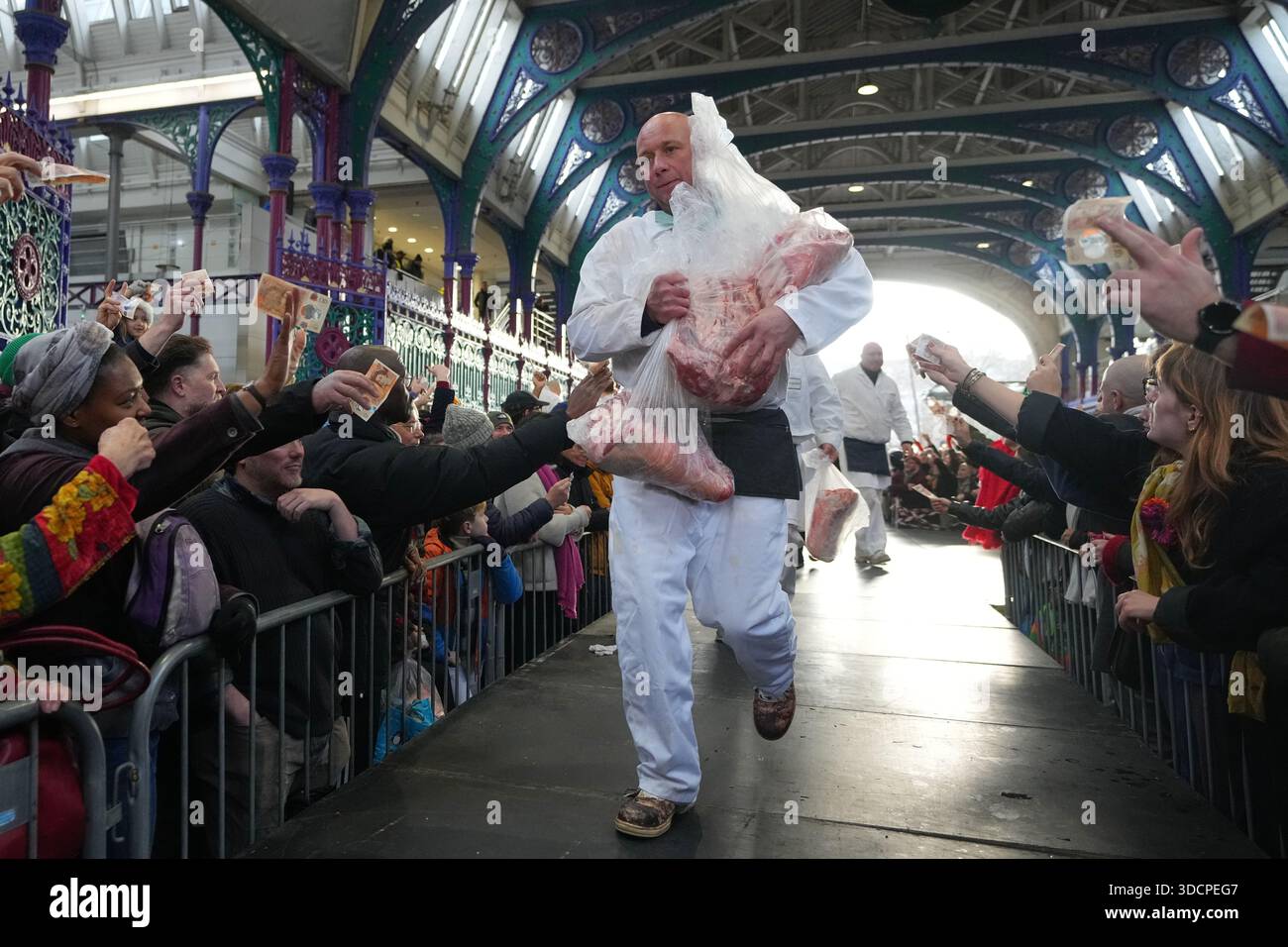Meat is held up during the annual Christmas Eve meat auction at ...