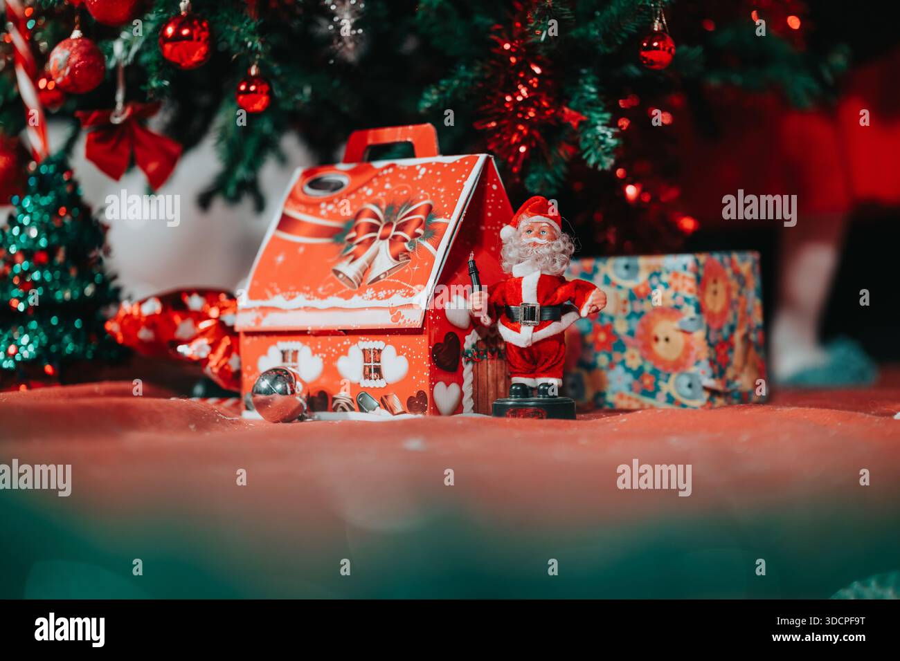 Christmas gifts under a festive tree with Santa figure and colorful ...