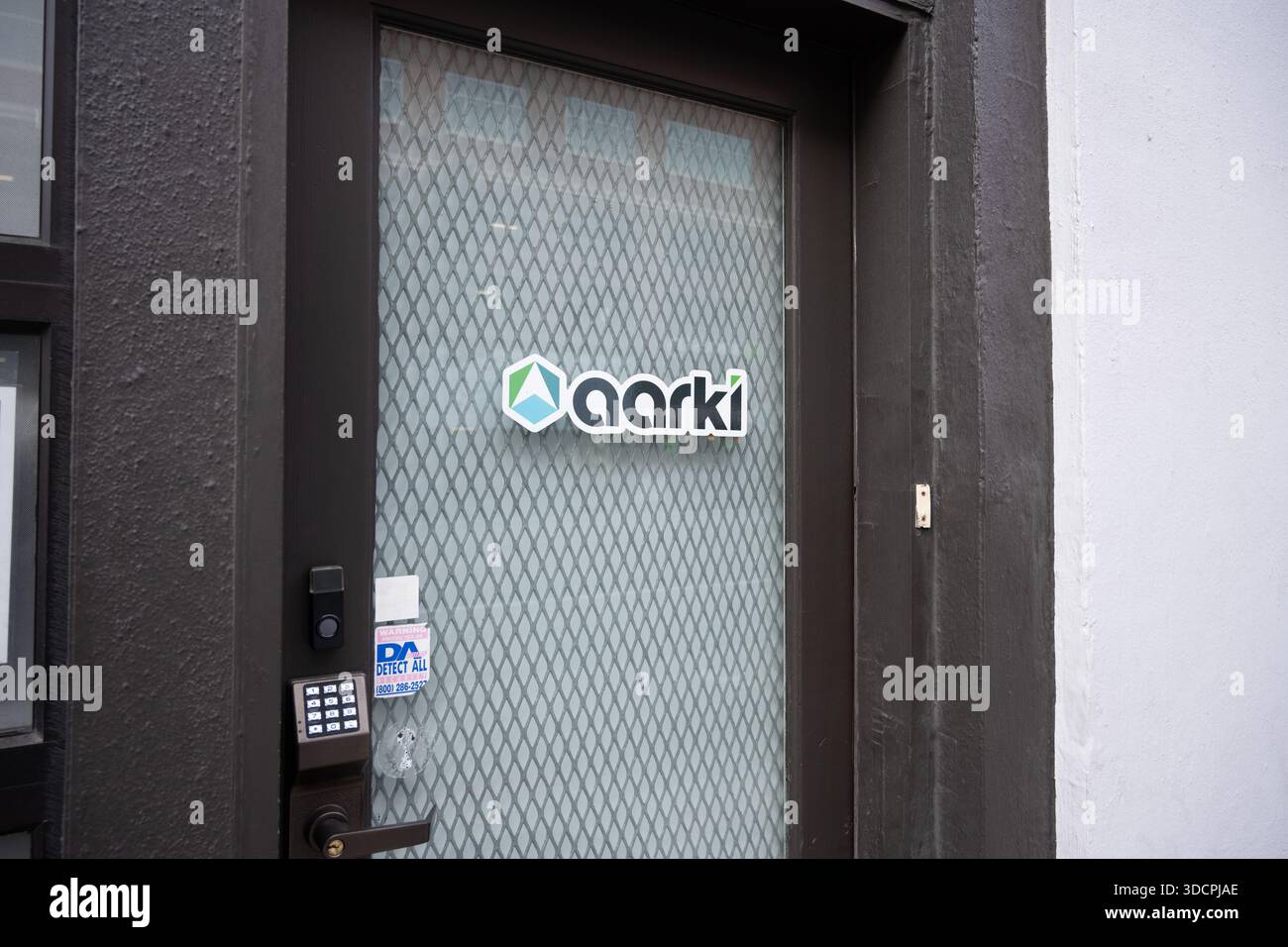 Office entrance door with Aarki logo, keypad lock, and textured glass ...