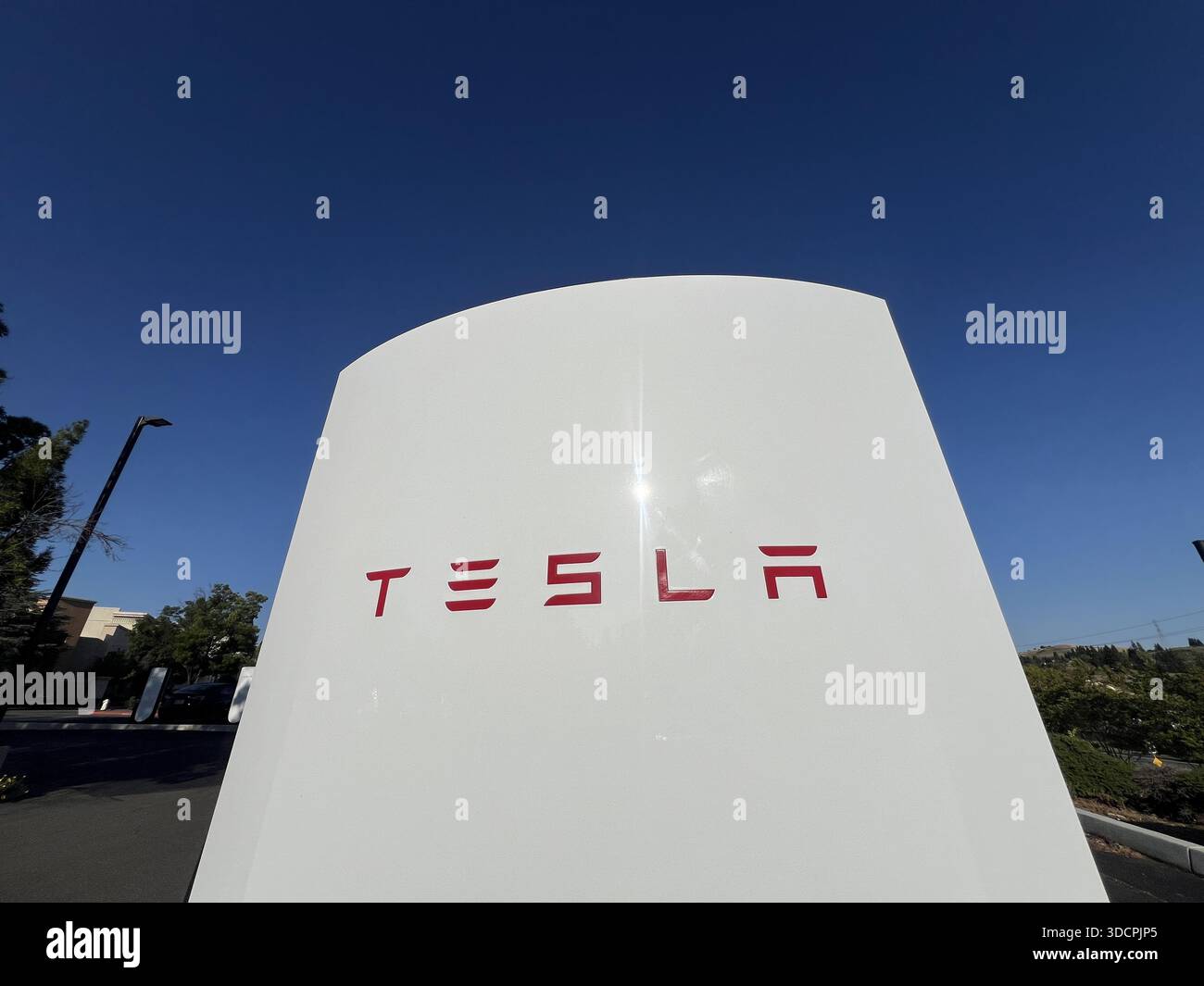 Close-up of Tesla Supercharger charging station signage on a sunny day ...