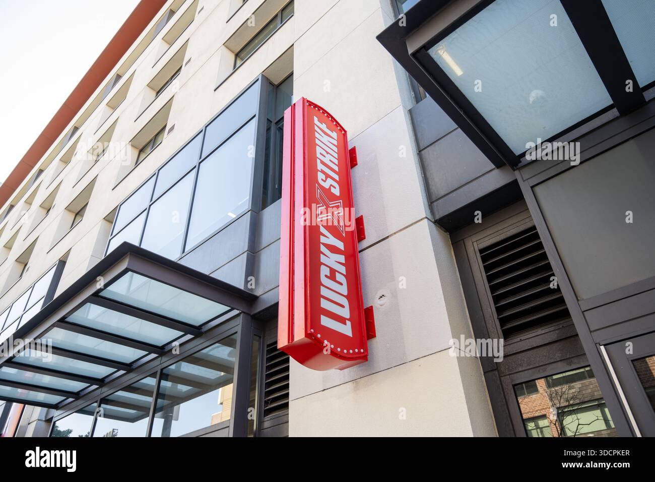 Lucky Strike vertical red sign on exterior of modern building with ...