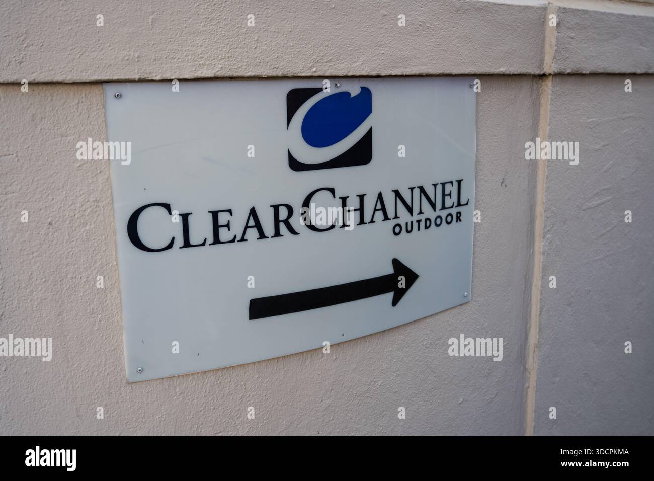 Clear Channel Outdoor directional sign mounted on exterior wall of ...