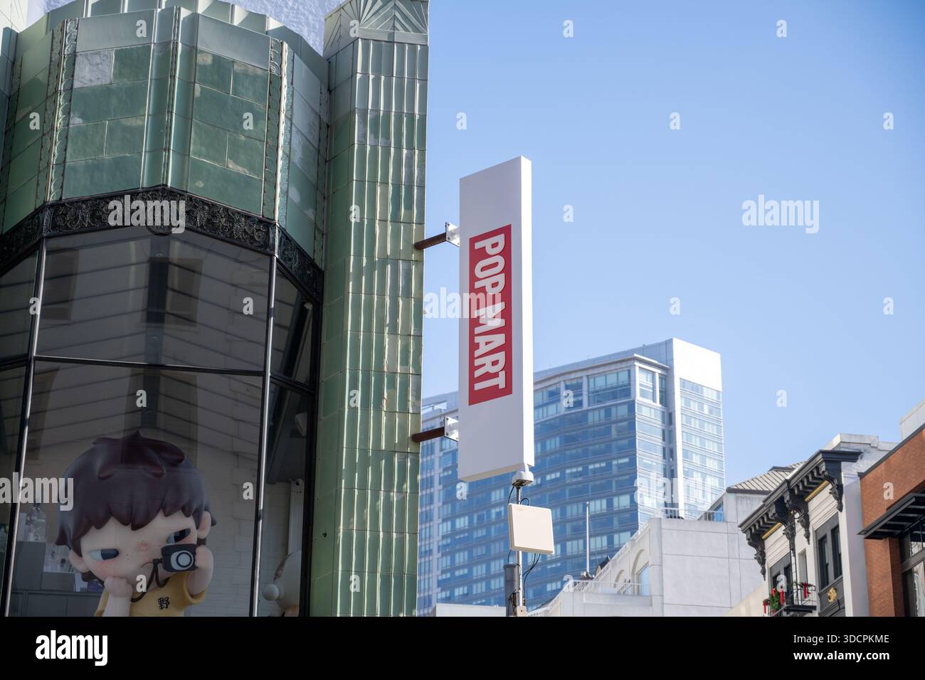 Vertical Pop Mart store sign on historic green-tiled building with ...