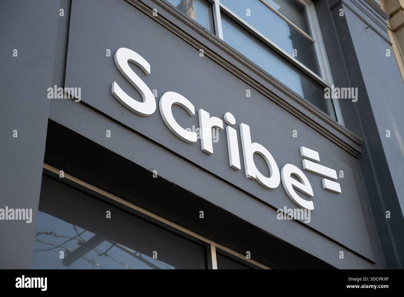 Close-up of Scribe office exterior signage on gray building facade, San ...