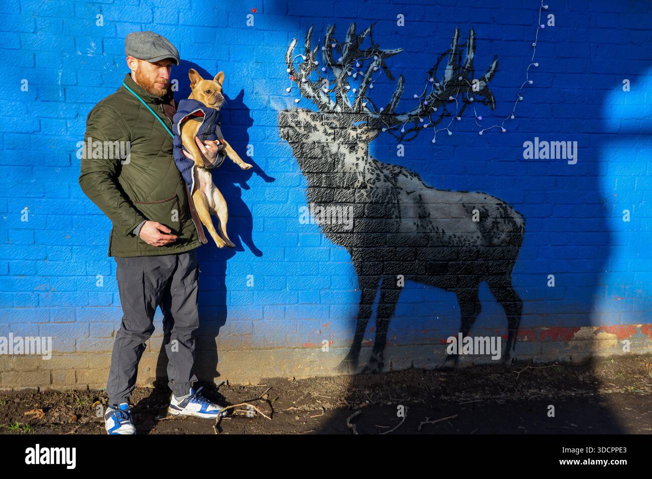 London. UK. 24 Dec 2025. A man with his dog pose next to an unconfirmed ...