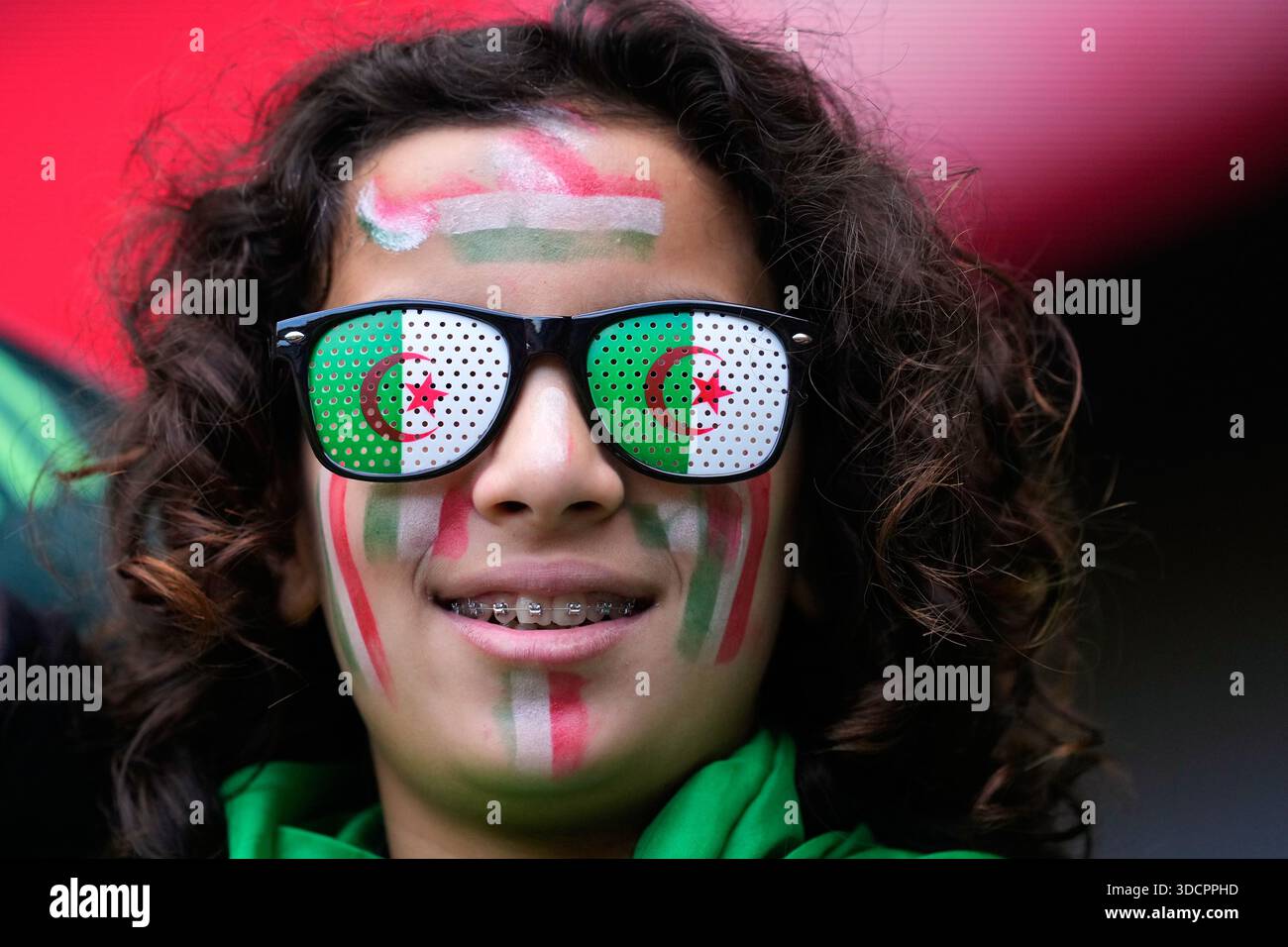 An Algeria fan with a painted face waits for the start of the Africa ...