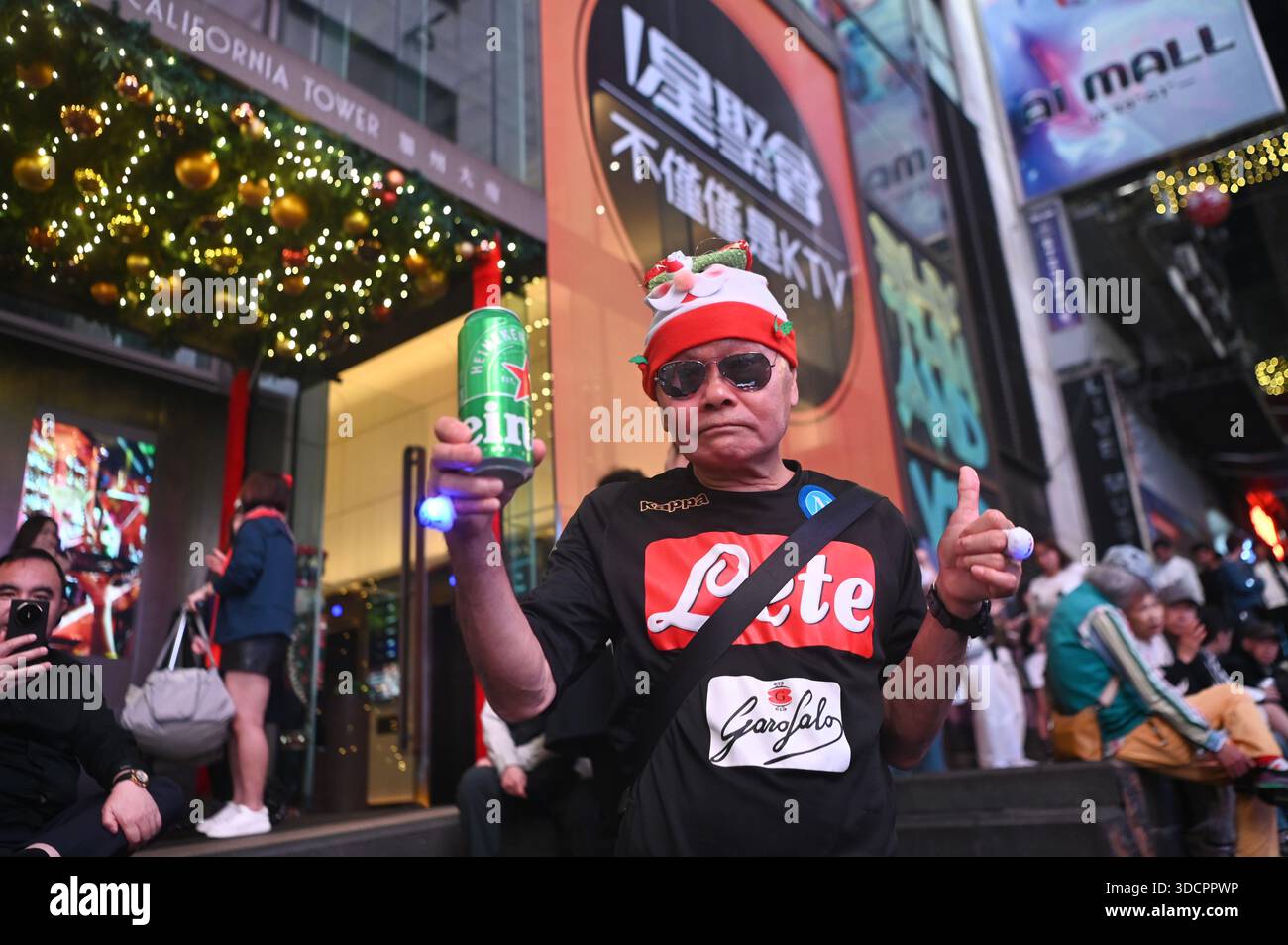A man posting photo at Lan Kwai Fong in Central on December 24, 2025 in ...