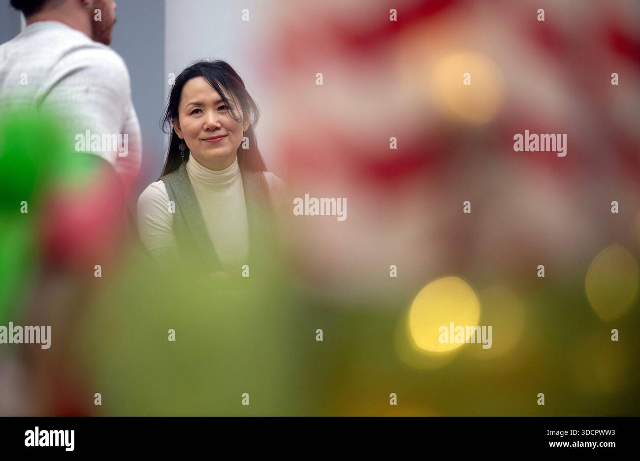 Ginok Song is seen at work taking family photos with Santa at the ...