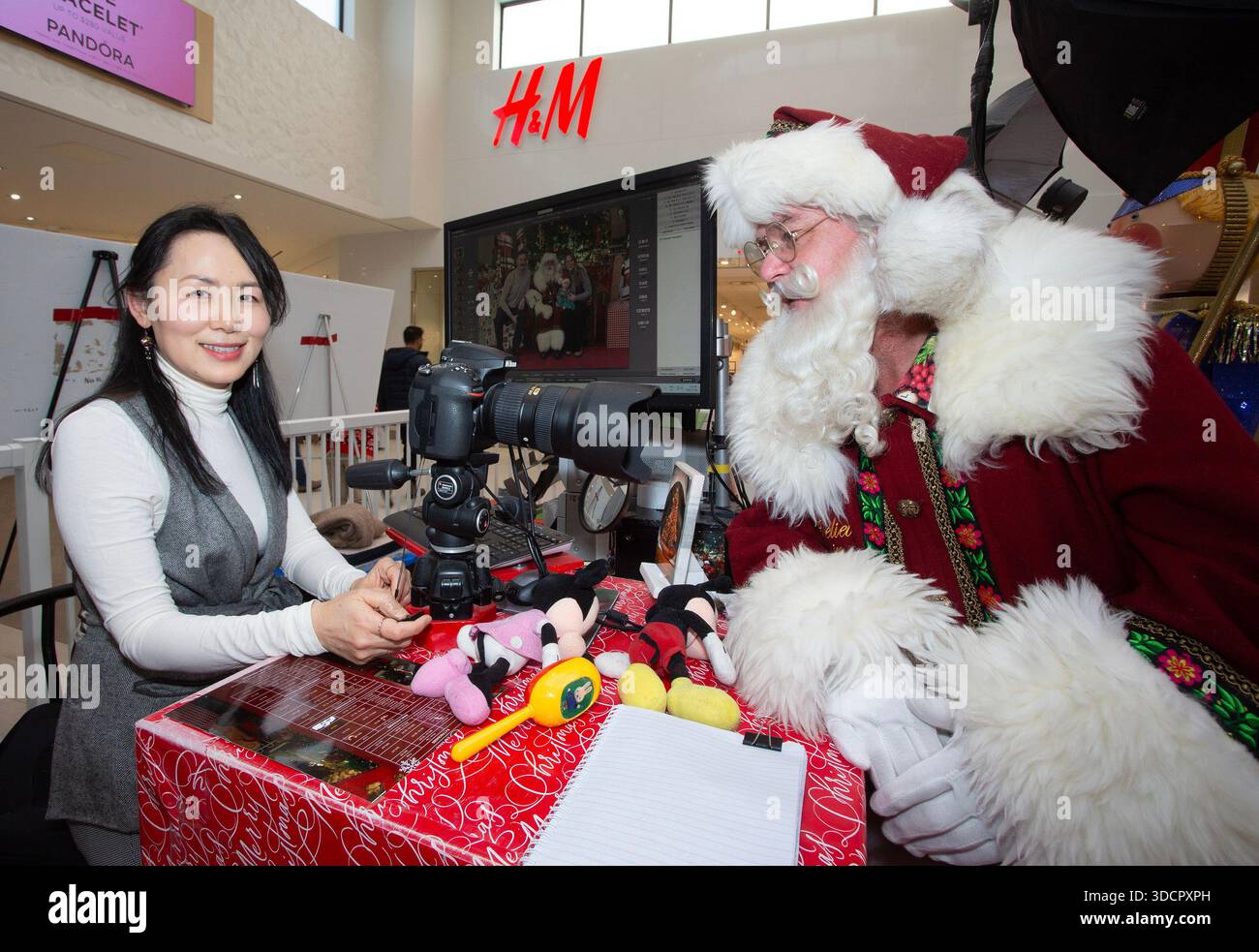 Ginok Song is seen at work taking family photos with Santa at the ...