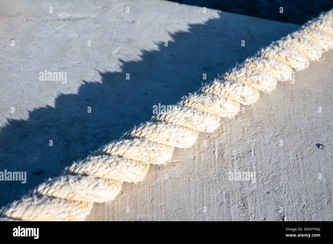 Weathered ship rope lying at the quay of BirÅ¼ebbuÄa, highlighting ...