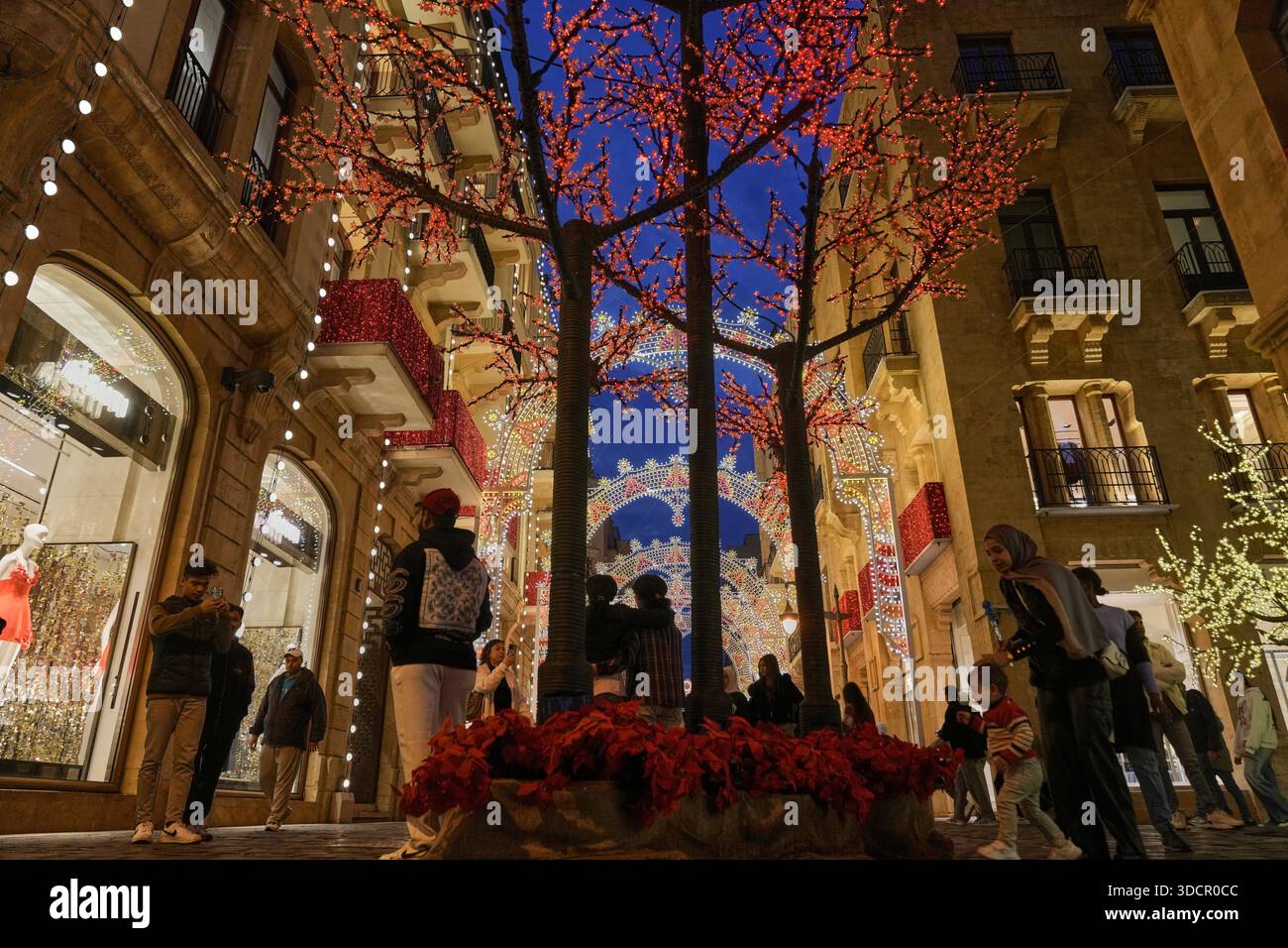 People walk past Christmas decorations in downtown Beirut, Lebanon ...