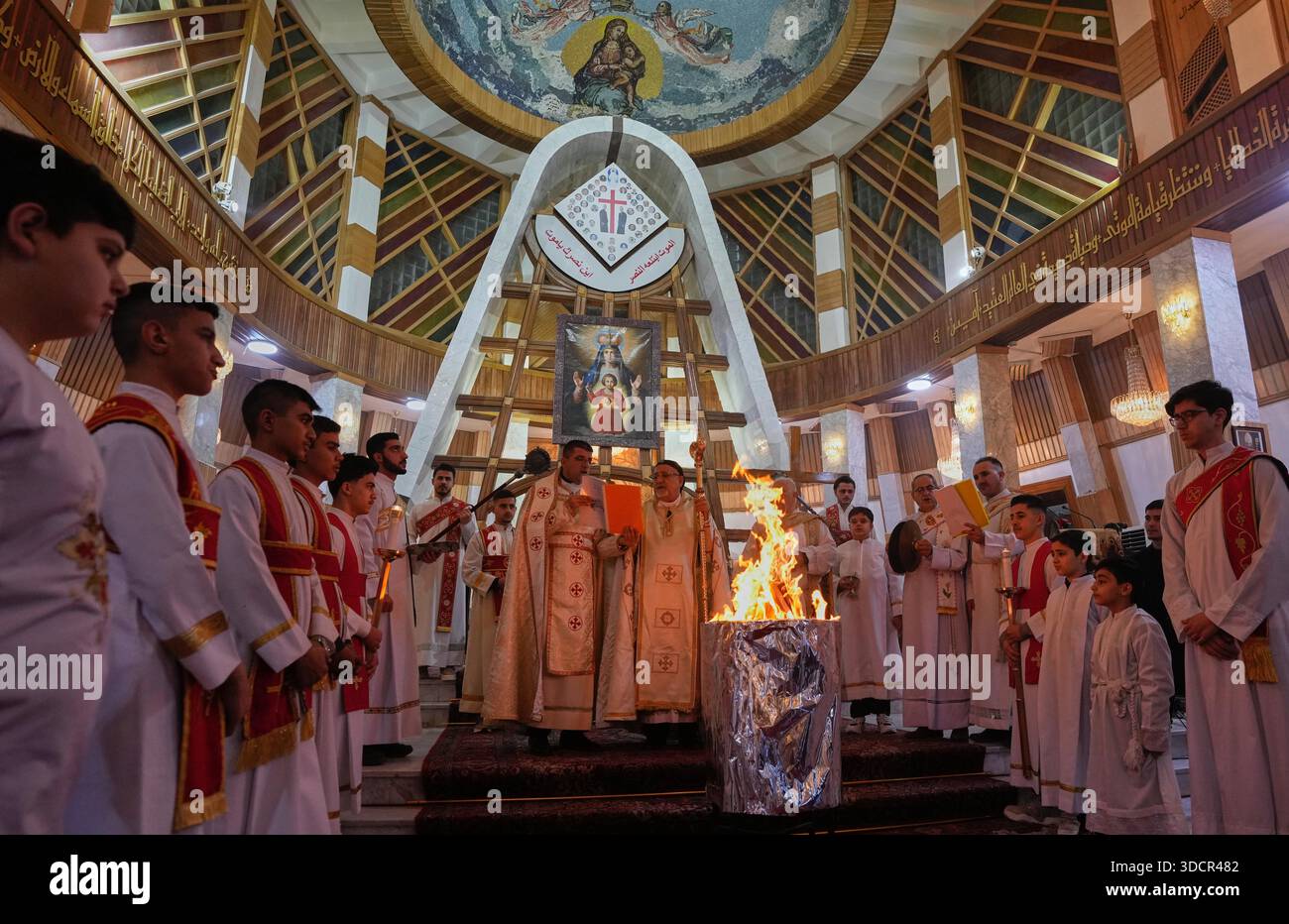 Iraqi priest Mokhles Shishah, center, leads prayers during Christmas ...