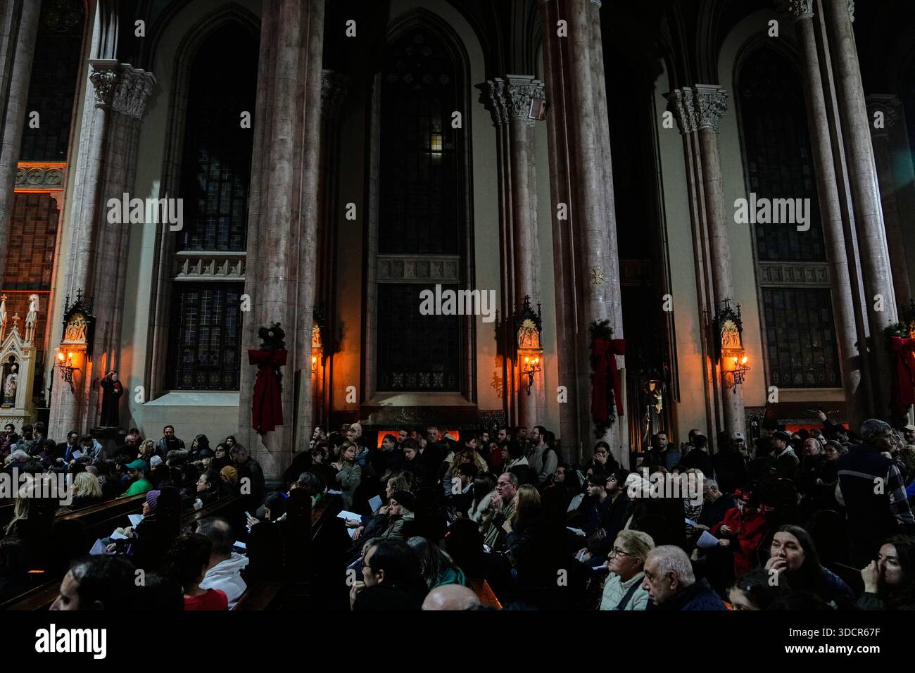 People attend a Catholic Christmas Eve mass in St. Antoine Church, in ...