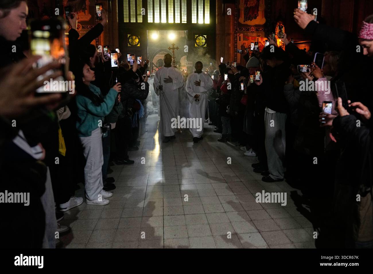 People attend a Catholic Christmas Eve mass in St. Antoine Church, in ...