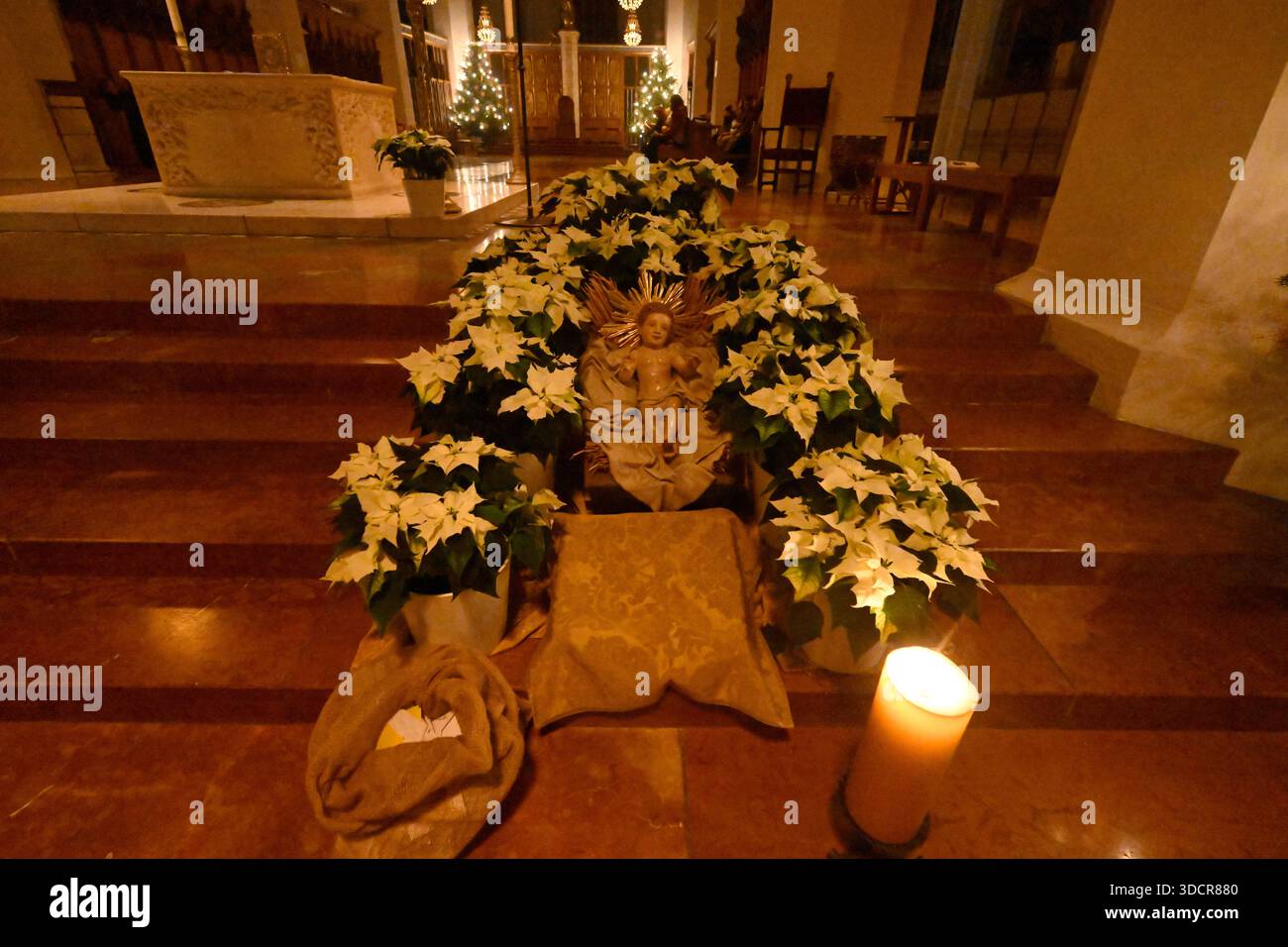 24 December 2025, Bavaria, Munich: A figure of the Christ Child lies on ...
