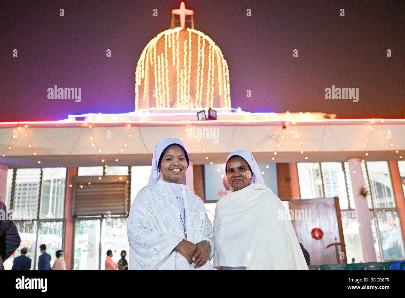 Nuns pose for a photograph in front of the decorated and illuminated ...