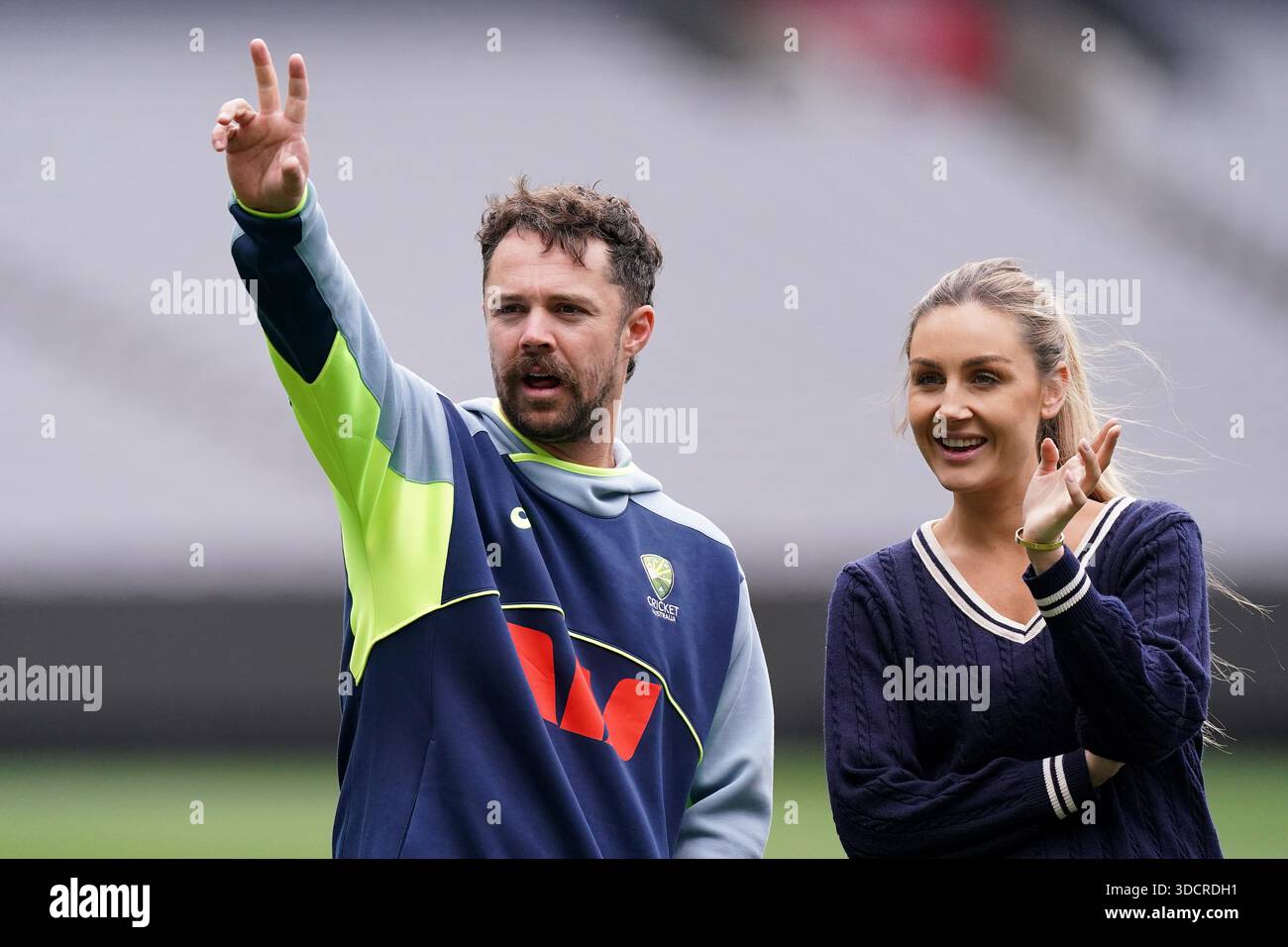 Australia's Travis Head waves to someone with his wife Jessica Head ...