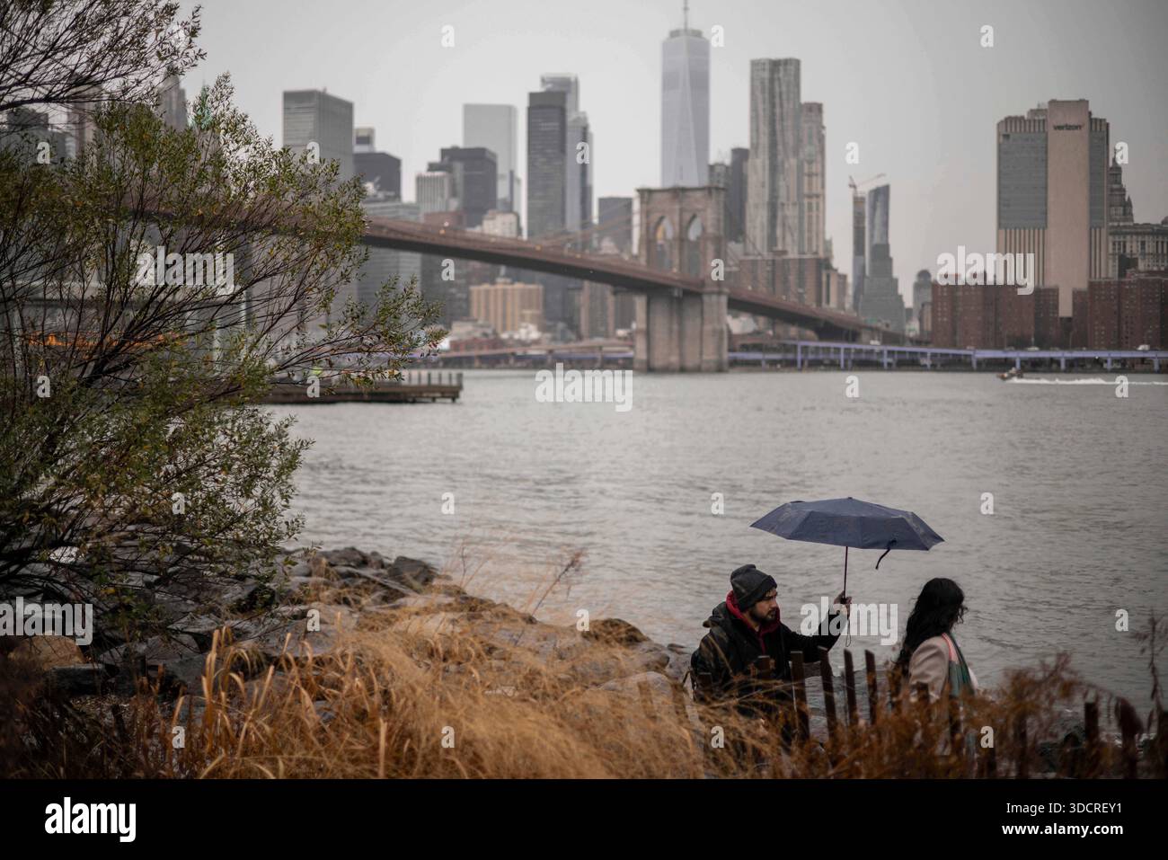 People watch the Manhattan cityscape, Tuesday, Dec. 23, 2025, in ...