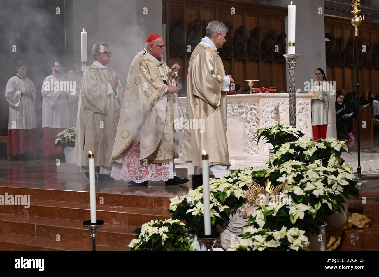 Cardinal Reinhard Marx passes in front of the altar with incense during ...