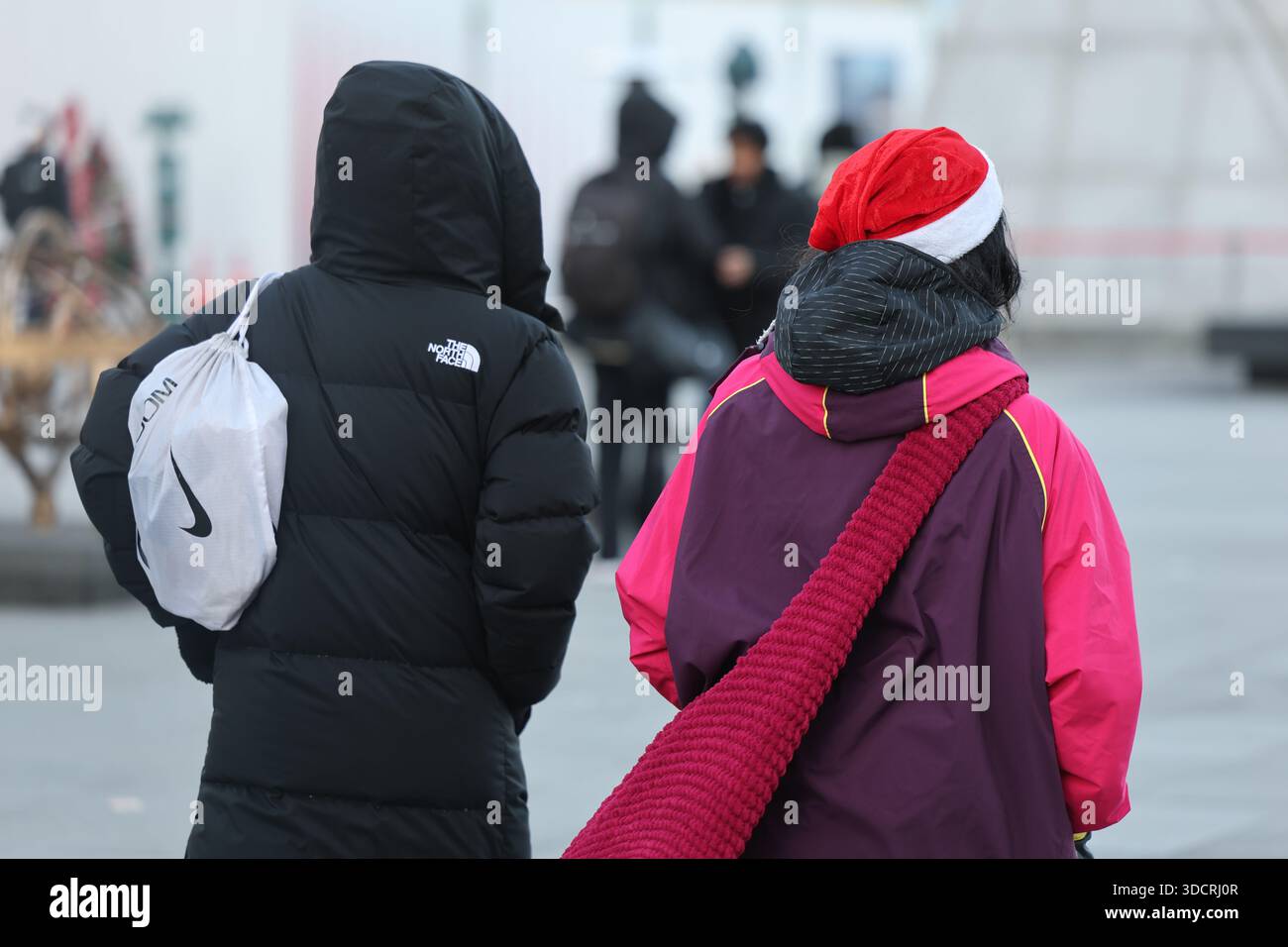 Cold snap on Christmas Day People wearing puffer jackets walk outside ...
