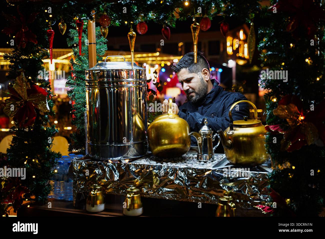 Erbil, Iraq. 23rd Dec, 2025. A tea vendor seen at his decorated cart at ...