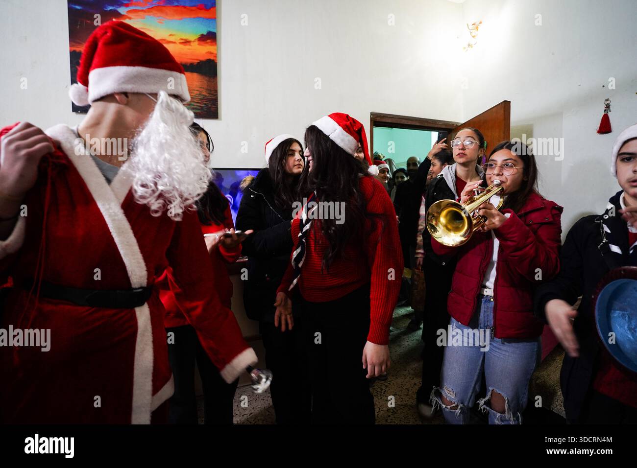 Syrian Orthodox refugees seen dressed as Santa Claus distribute gifts ...