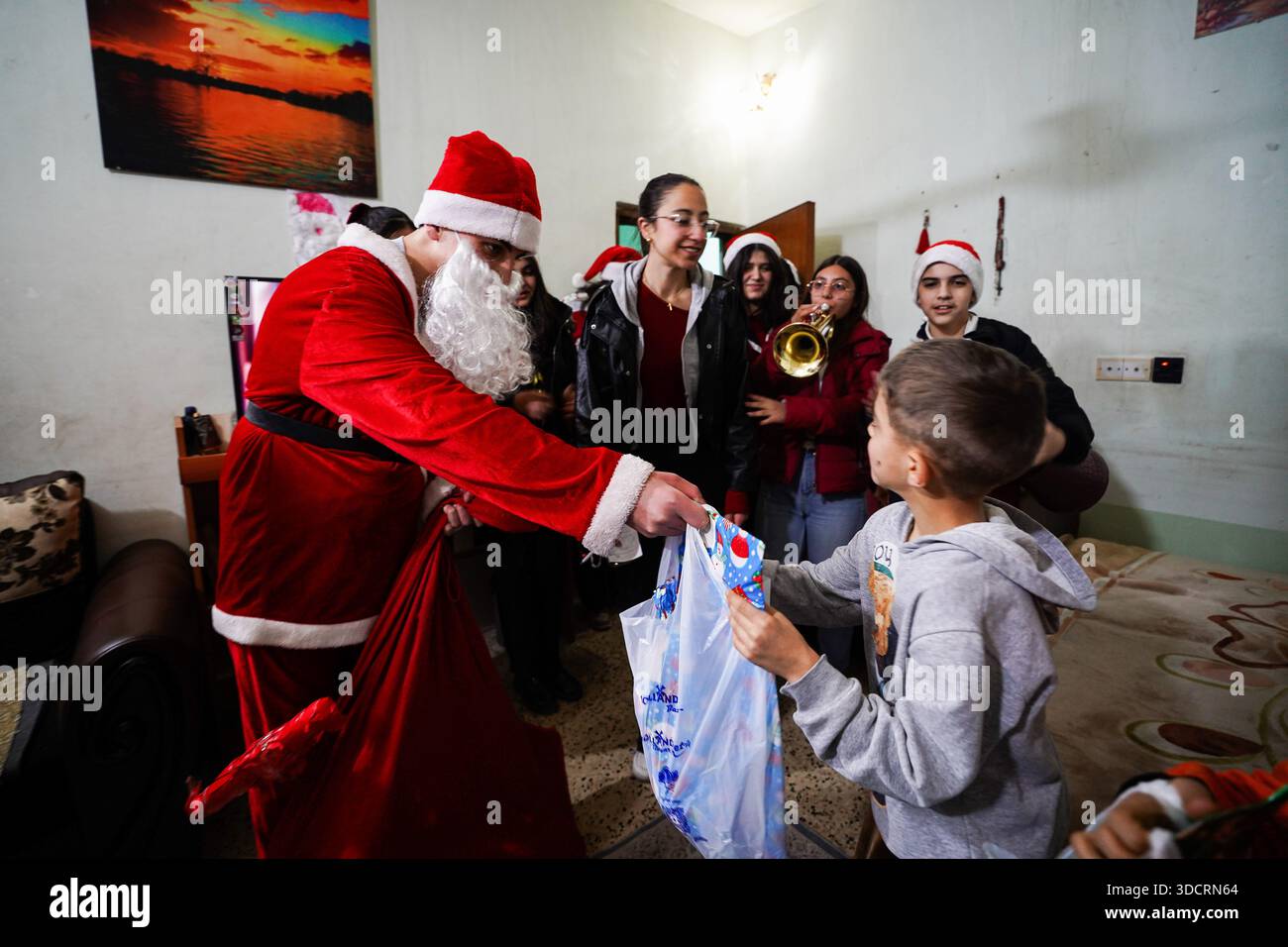An Orthodox Syrian refugee seen dressed as Santa Claus distributes ...