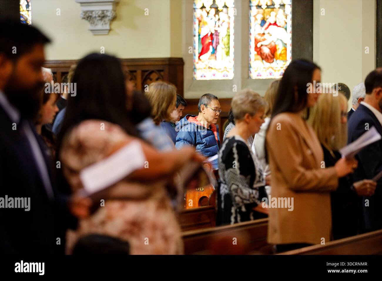 Attendees are seen singing hymns during the Christmas Day Mass at Scots ...