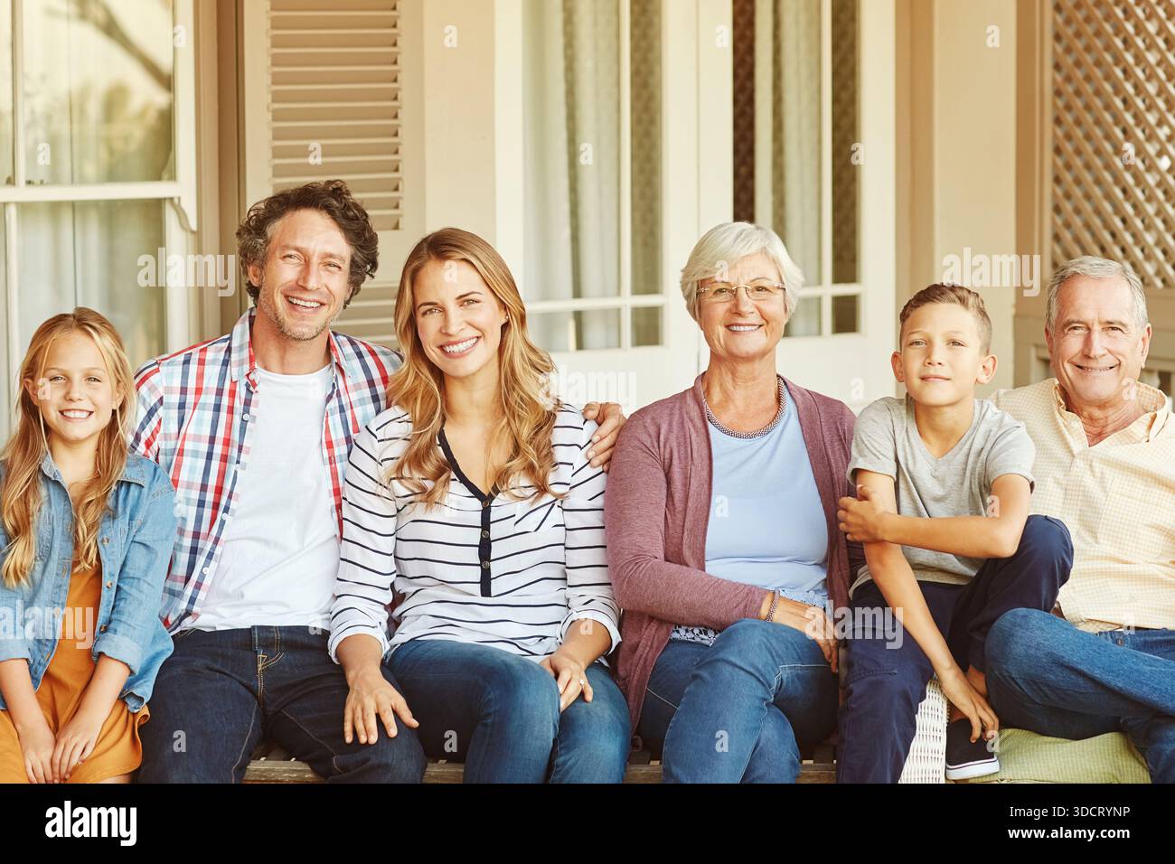 Parents, grandparents and kids in portrait on patio, happy with hug ...