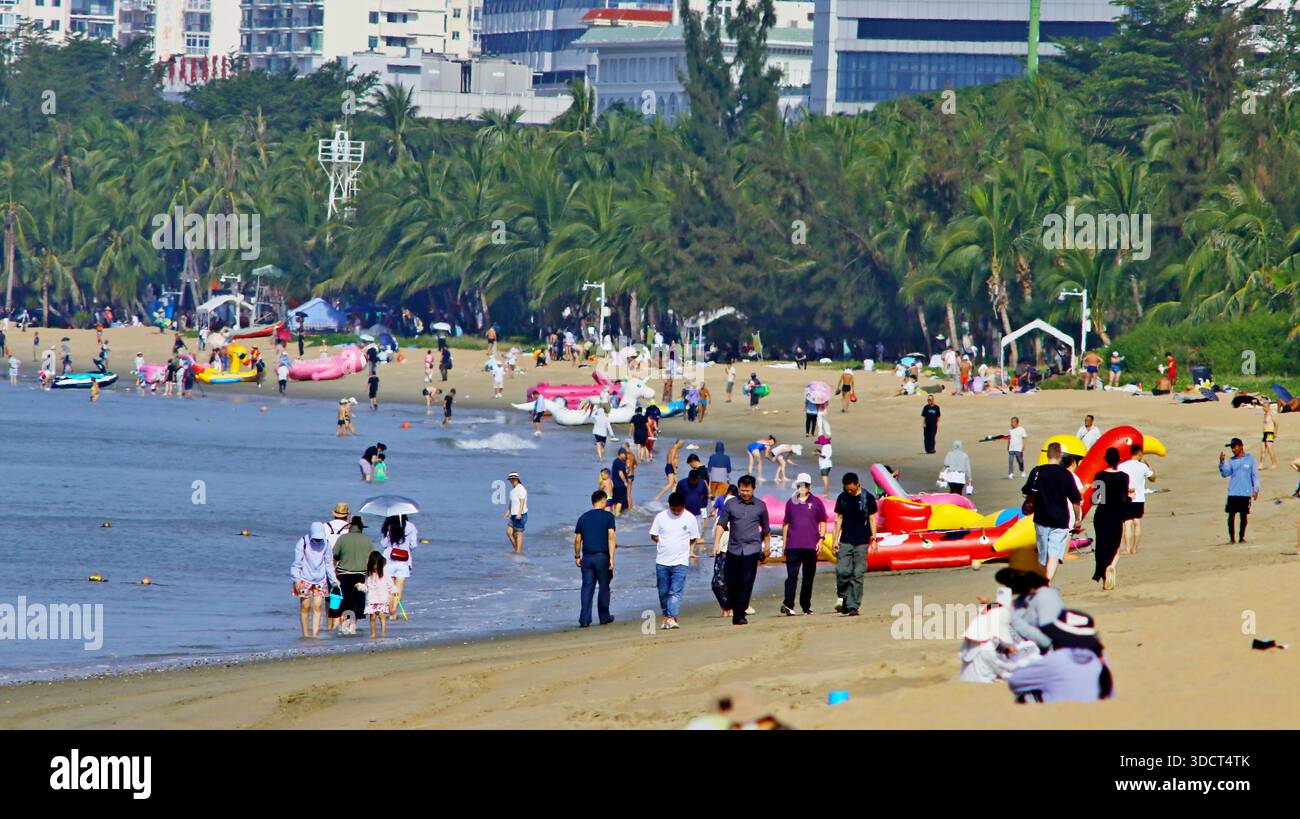 Tourists enjoy the sunny beaches during winter in Sanya, south China's ...
