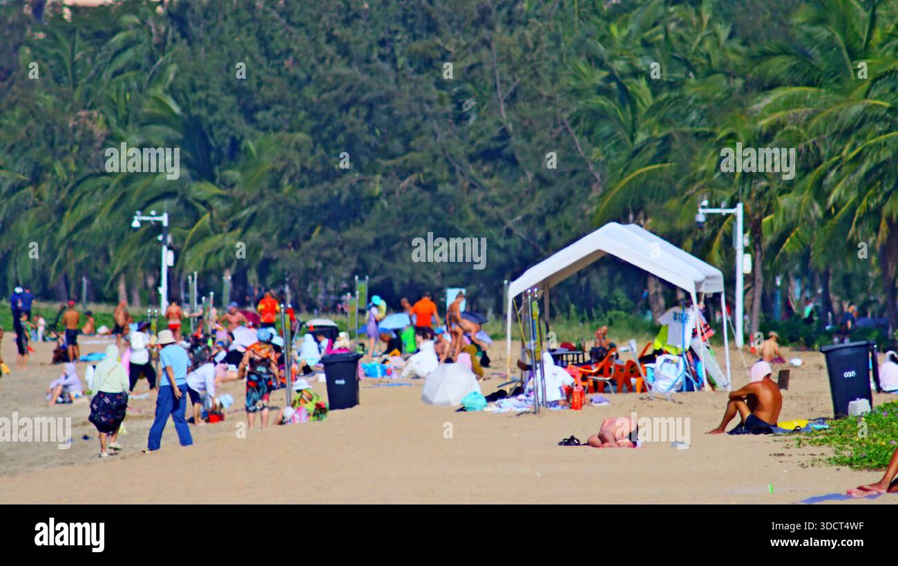 Tourists enjoy the sunny beaches during winter in Sanya, south China's ...