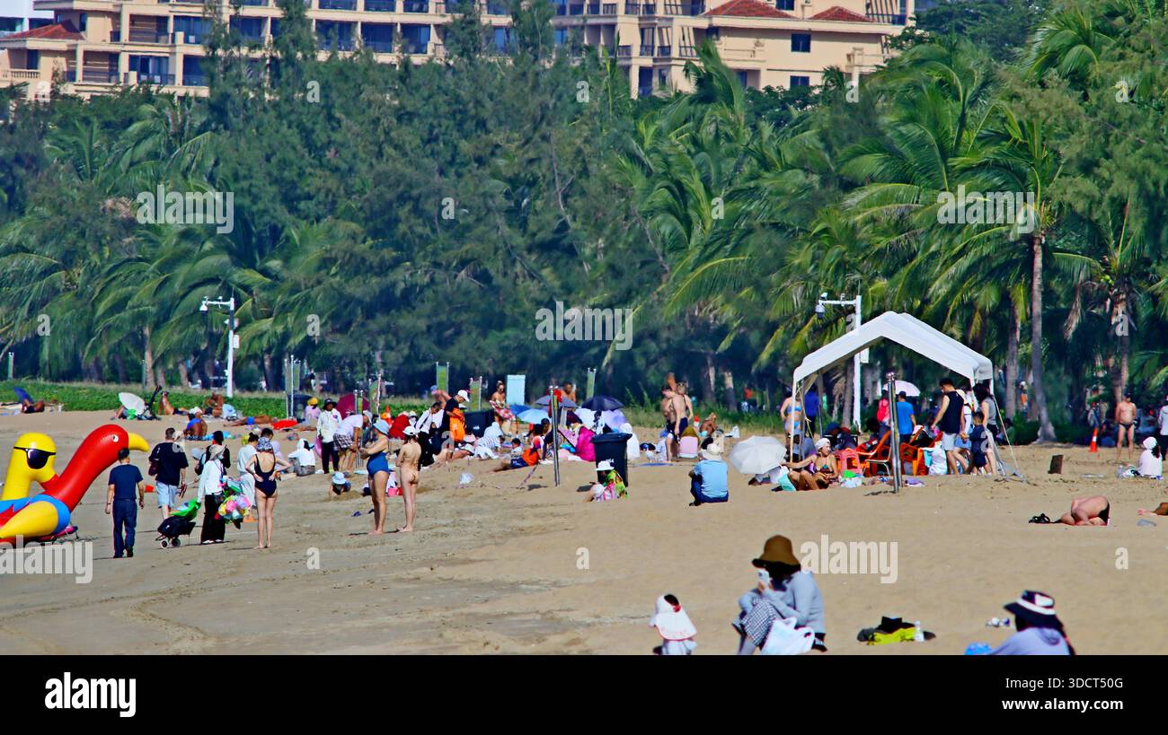 Tourists enjoy the sunny beaches during winter in Sanya, south China's ...