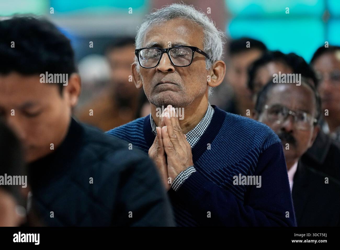 An elderly Indian man attends Christmas prayers at a Church in Guwahati ...