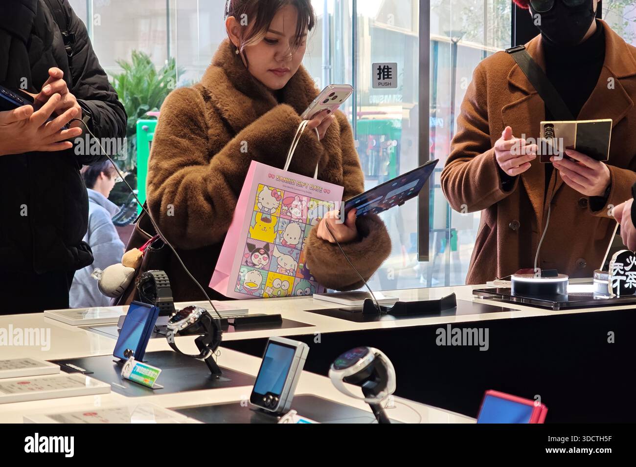 SHANGHAI, CHINA - DECEMBER 25, 2025 - Customers experience the Galaxy Z ...