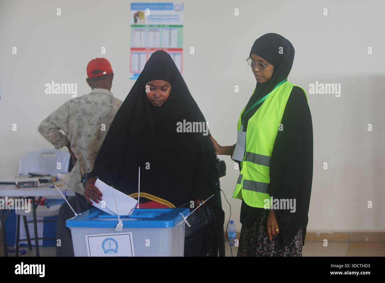 A woman casts her vote during the local election in Mogadishu, Somalia ...
