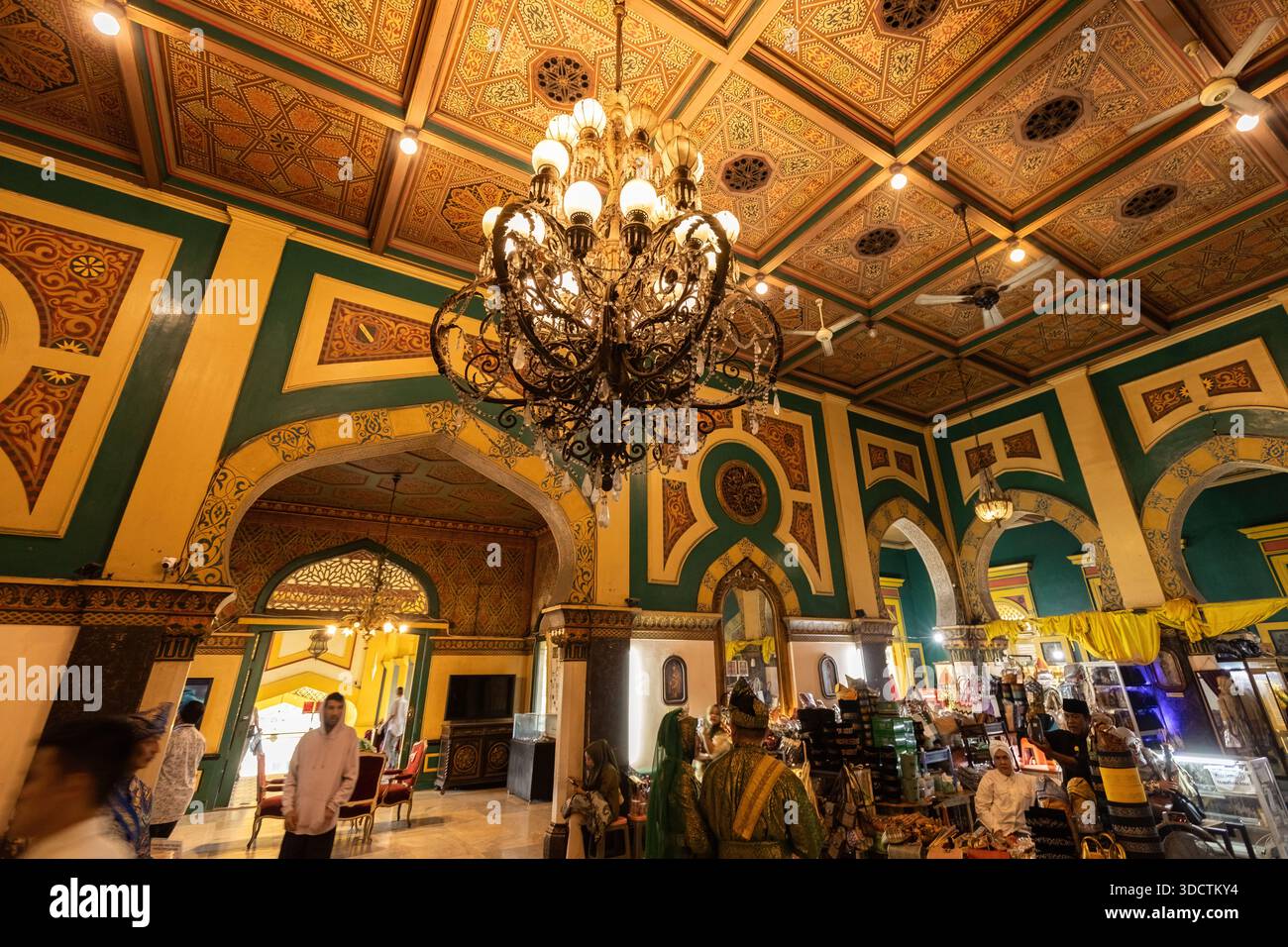 Ornate chandelier and richly decorated ceiling inside the Maimoon ...
