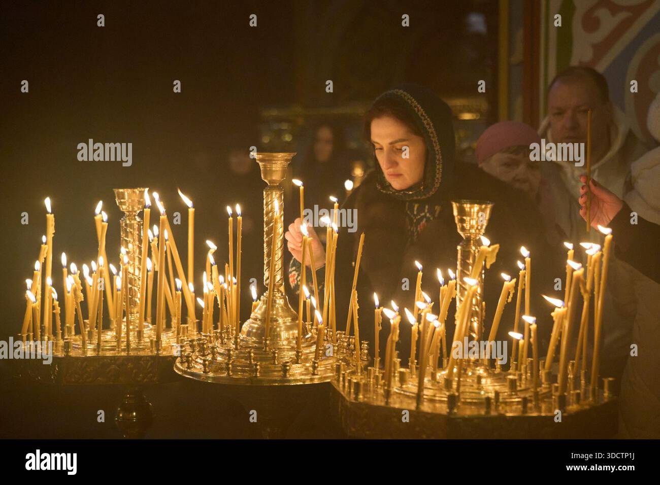 People light candles inside St. Michael's Golden-Domed Monastery to ...
