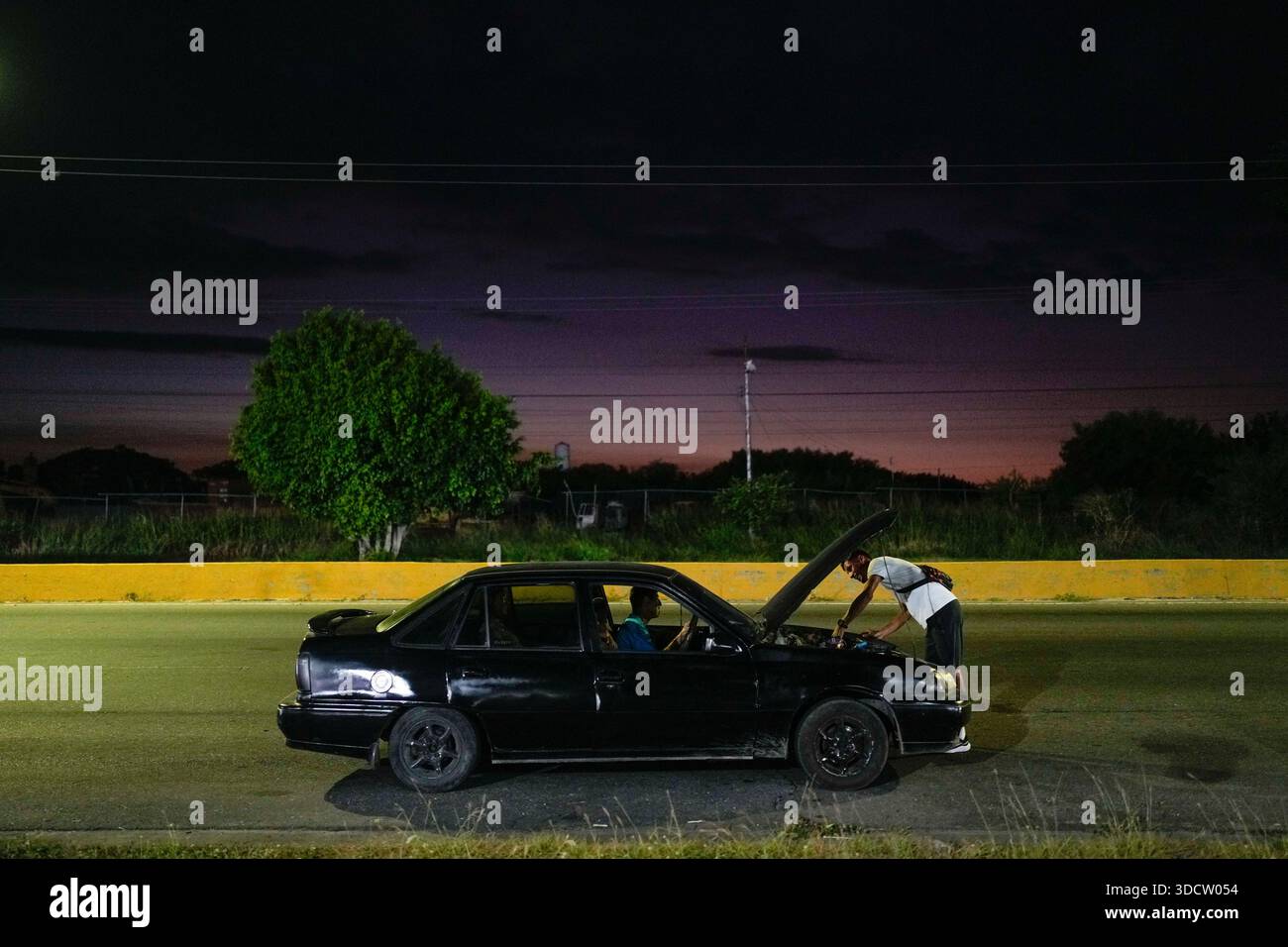 Abraham Castro helps fix the taxi taking him and his partner, Mariela ...