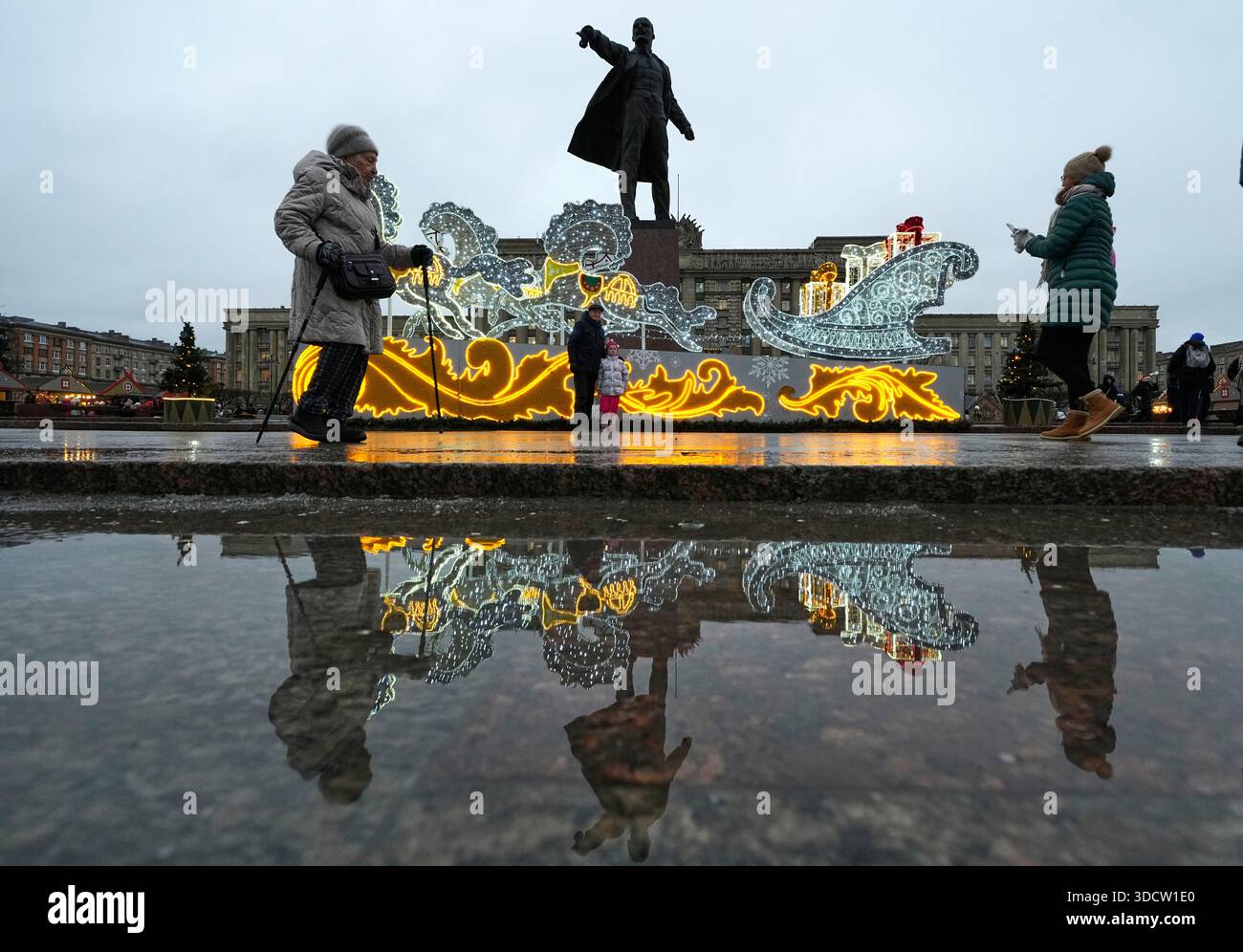 People walk at a Christmas fair opened prior to Christmas and New Year ...
