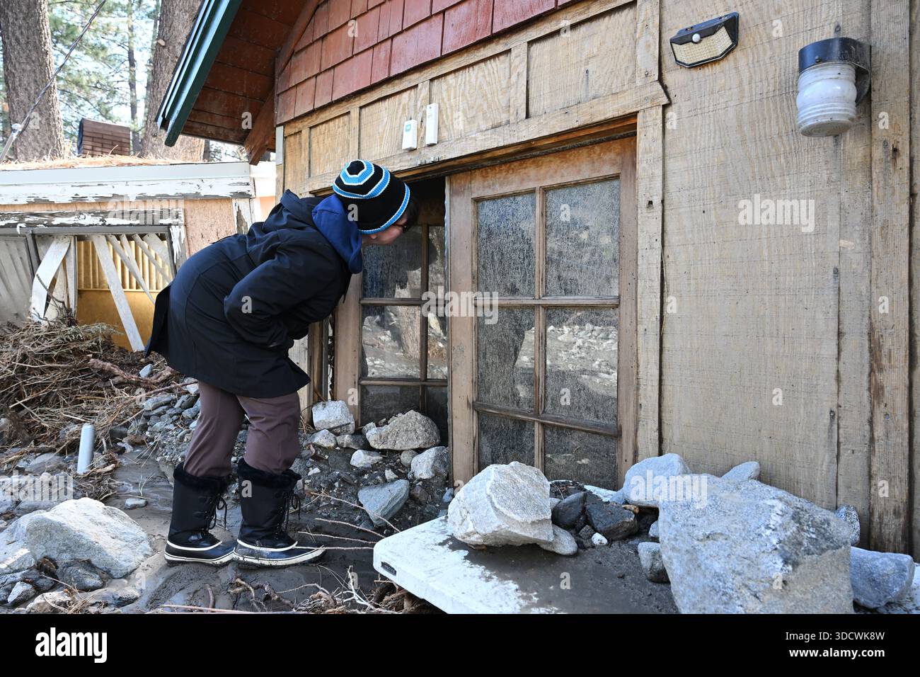 Michelle Meyers inspects her property, buried in mud after a series of ...