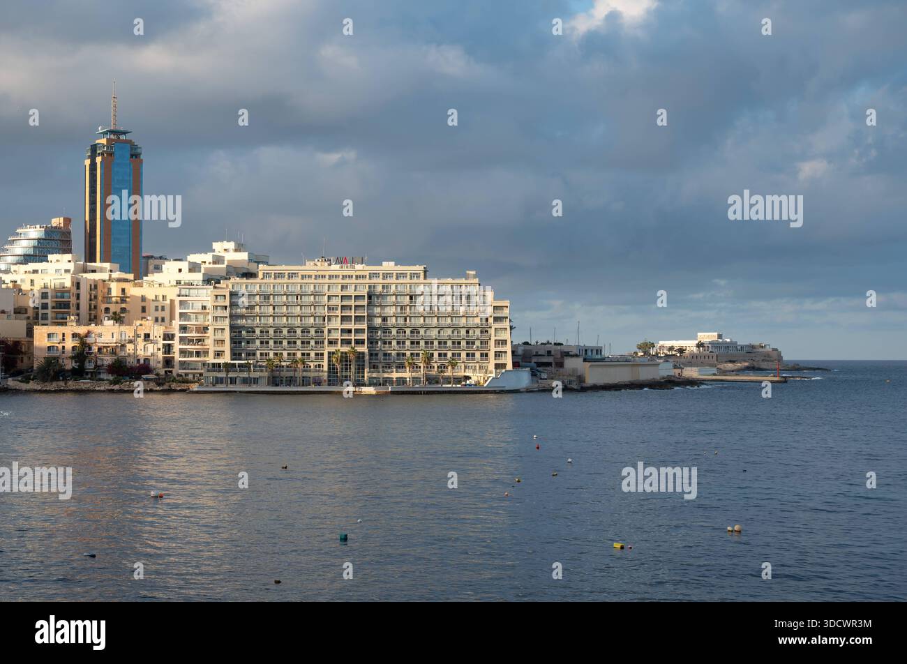 Saint Julians Bay and Spinola Bay at dusk with colorful sky reflections ...