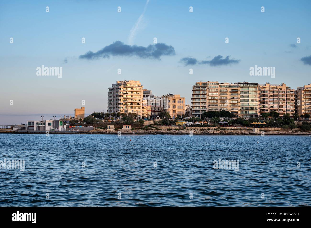 Saint Julians Bay and Spinola Bay at dusk with colorful sky reflections ...