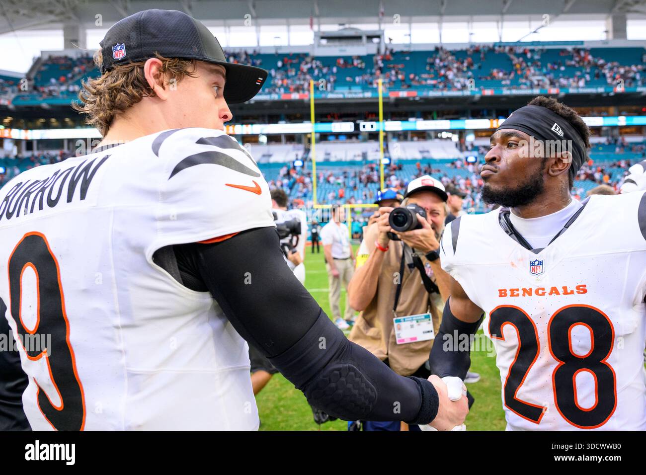 Cincinnati Bengals quarterback Joe Burrow (9) and cornerback Josh ...