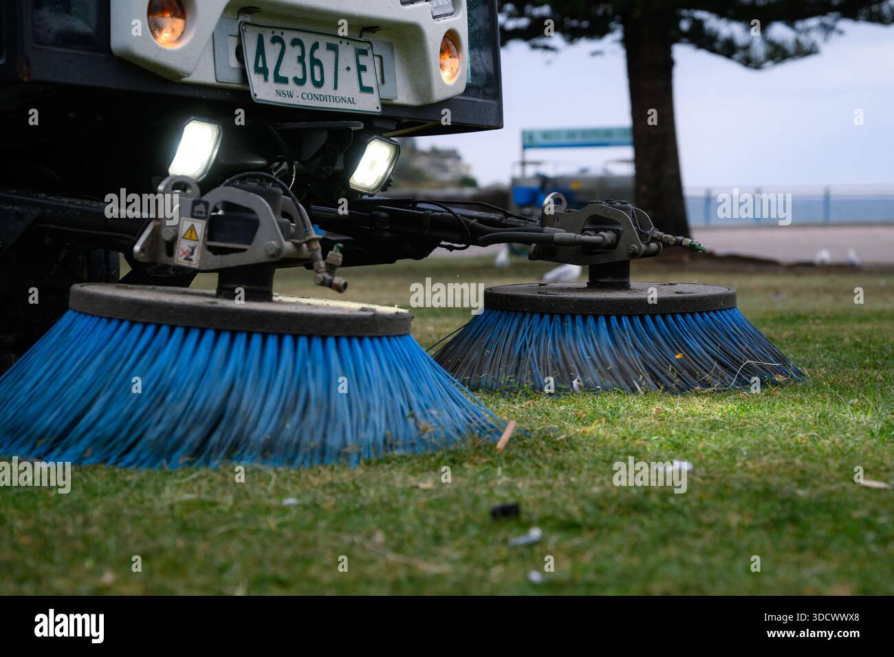 A street sweeper cleans up the rubbish left on the lawn after the ...