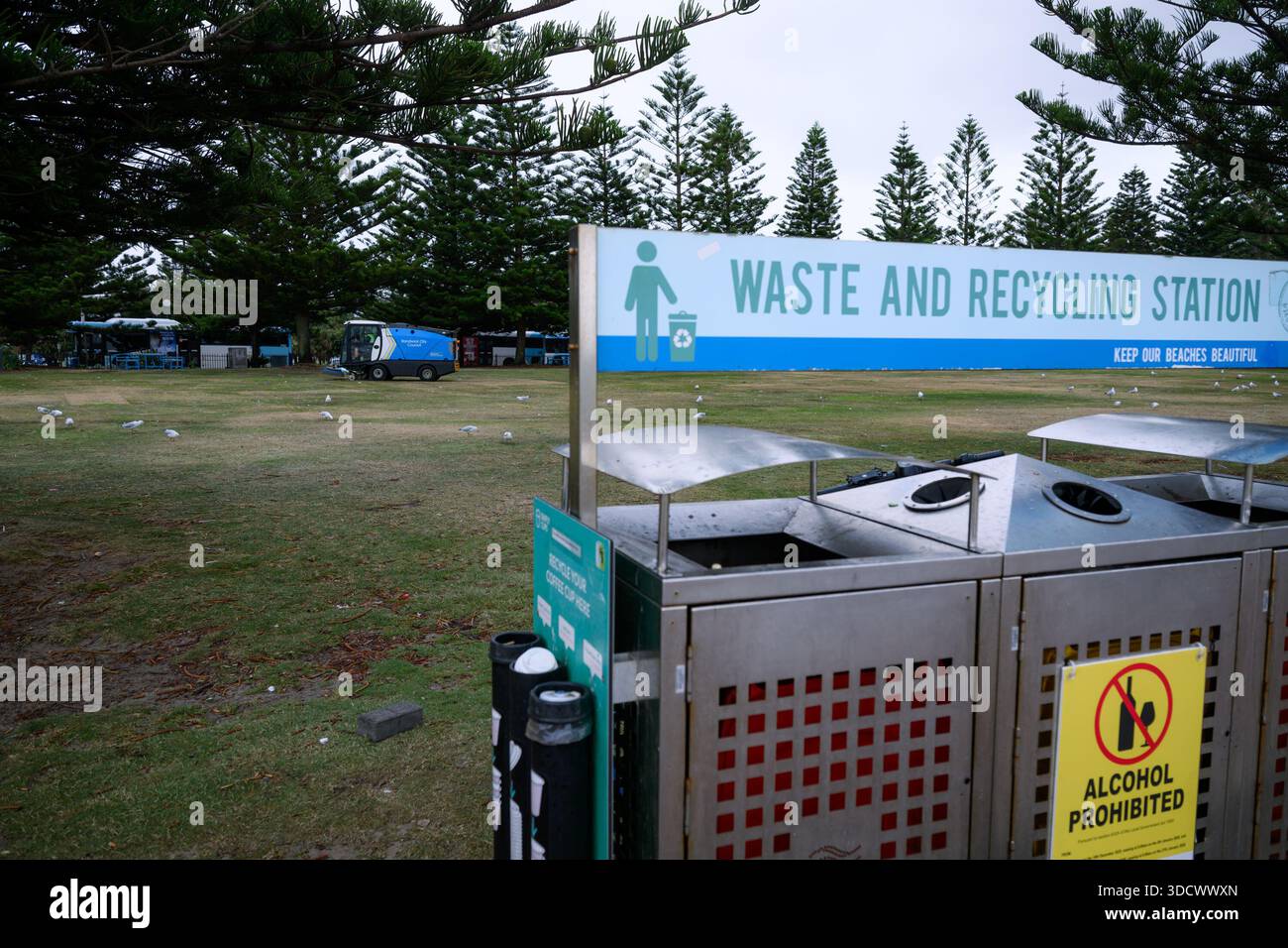 Waste and recycling station with a street sweeper in the background at ...