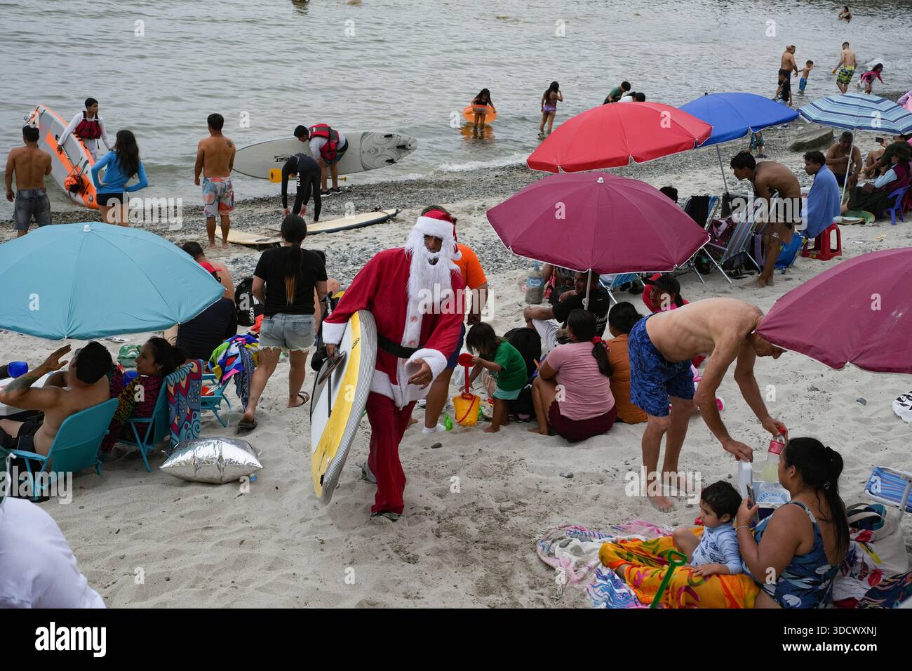 Daniel Alvistur, dressed as Santa Claus, leaves San Bartolo Beach after ...
