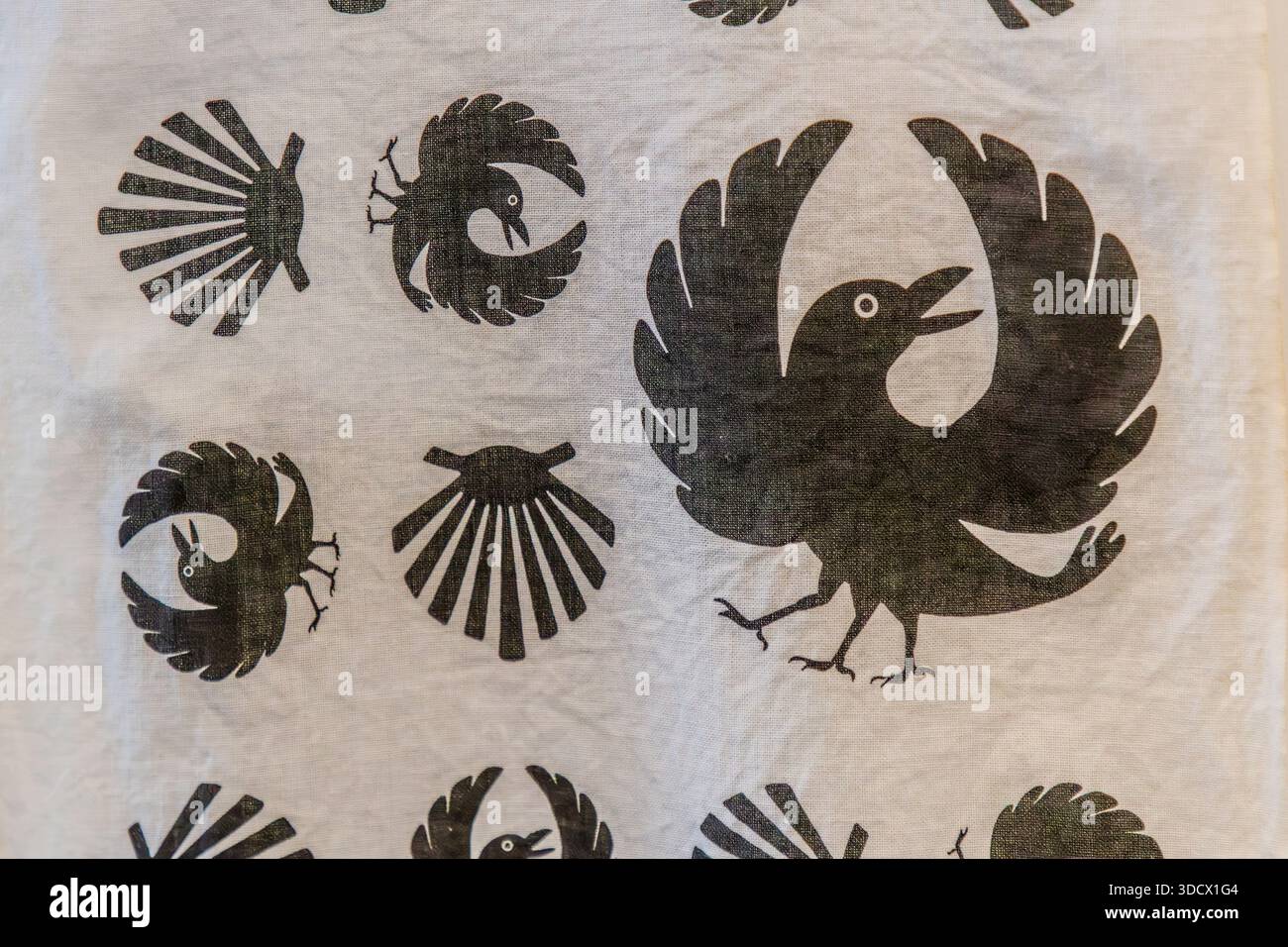 Black bird and shell patterns on white fabric. The three-legged crow ...